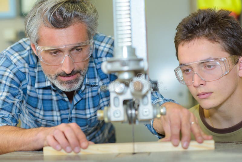Apprentice Watching Tutor Using Bench Saw Stock Image - Image of ...