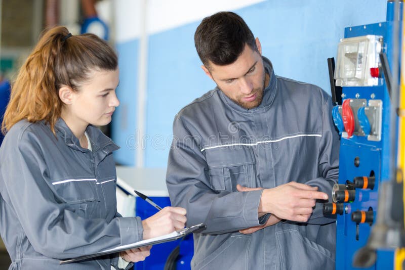 Apprentice Working on Machine Stock Photo - Image of protectivegoggles ...