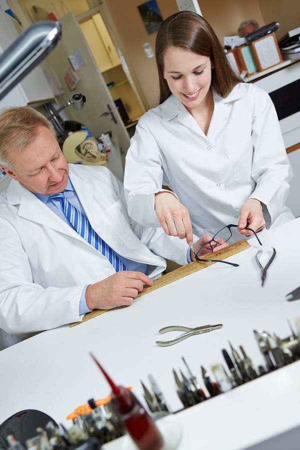 Apprentice in Workshop of Optician Stock Photo - Image of reading ...