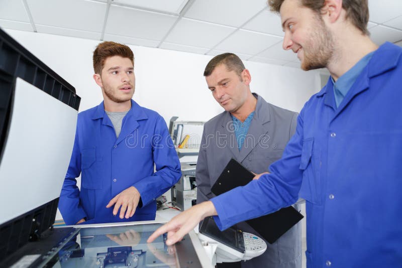 Apprentices Around the Printer Stock Image - Image of machine, teaching ...