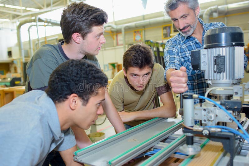Apprentices Learning To Use Machine Stock Photo - Image of standing ...