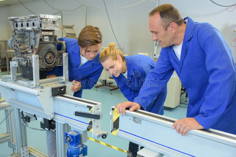 Apprentices Looking at Machinery Stock Photo - Image of conveyor ...