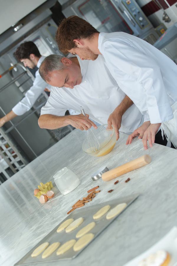Apprentices in Pastry Learning with Experienced Chef Stock Photo ...