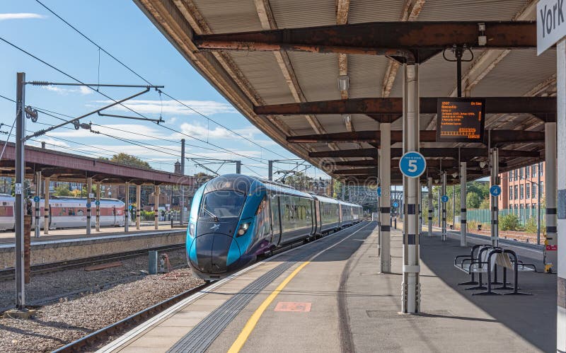 Approaching Railway Train at a Railway Station Platform. Editorial ...