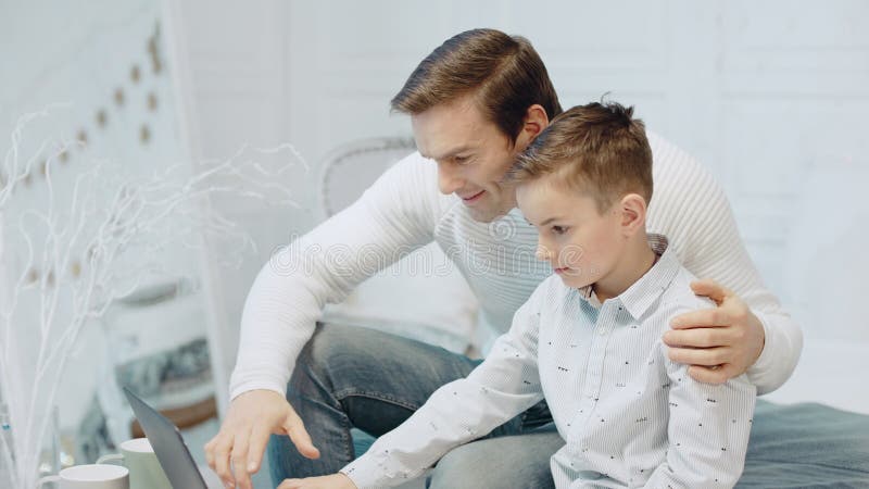 Appy Father Hugging Son Looking Computer Screen in Modern Apartment ...