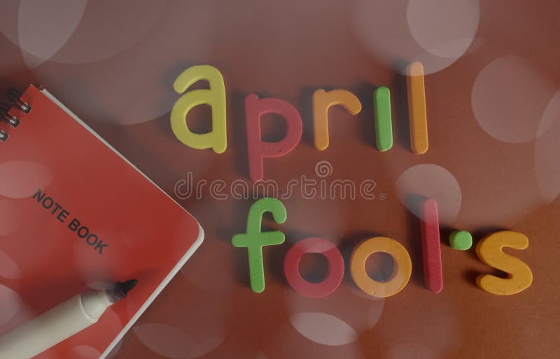 April Fools Text in Various Colours and Note Book Isolated in Brown ...