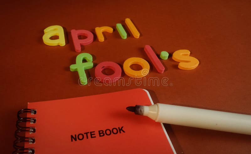 April Fools Text in Various Colours and Note Book Isolated in Brown ...