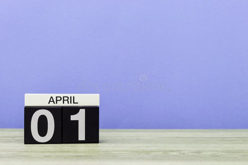 April - Wooden Carved Word on Yellow Background. Spring Time, 1st of ...