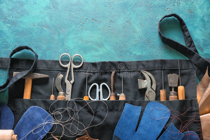 Apron with Craft Tools and Leather on Color Background Stock Photo ...
