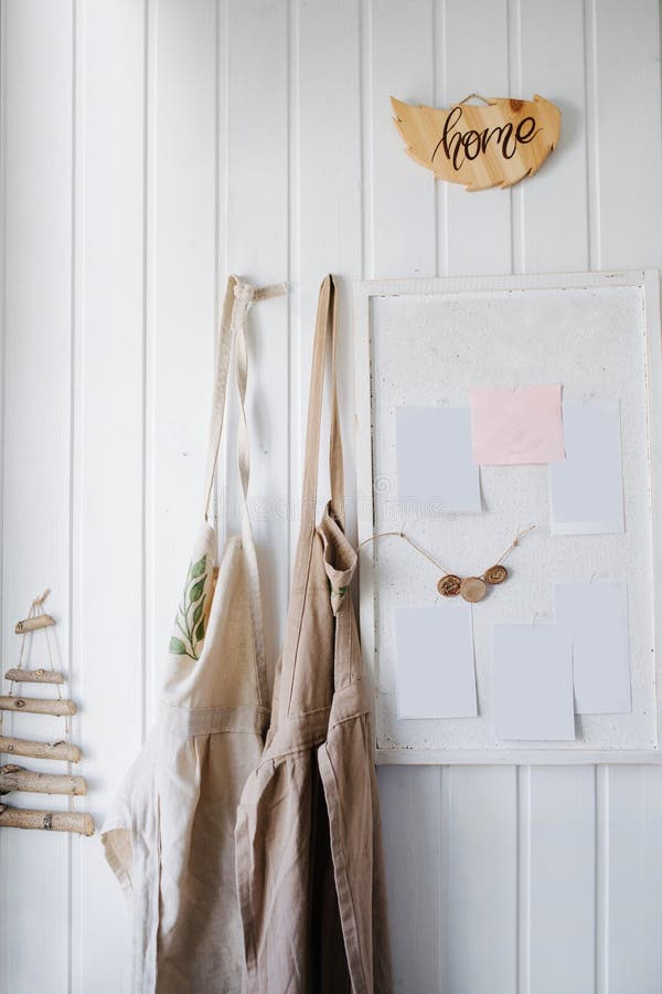 Aprons and a Board for Notes Hang on a White Wall Stock Photo - Image ...