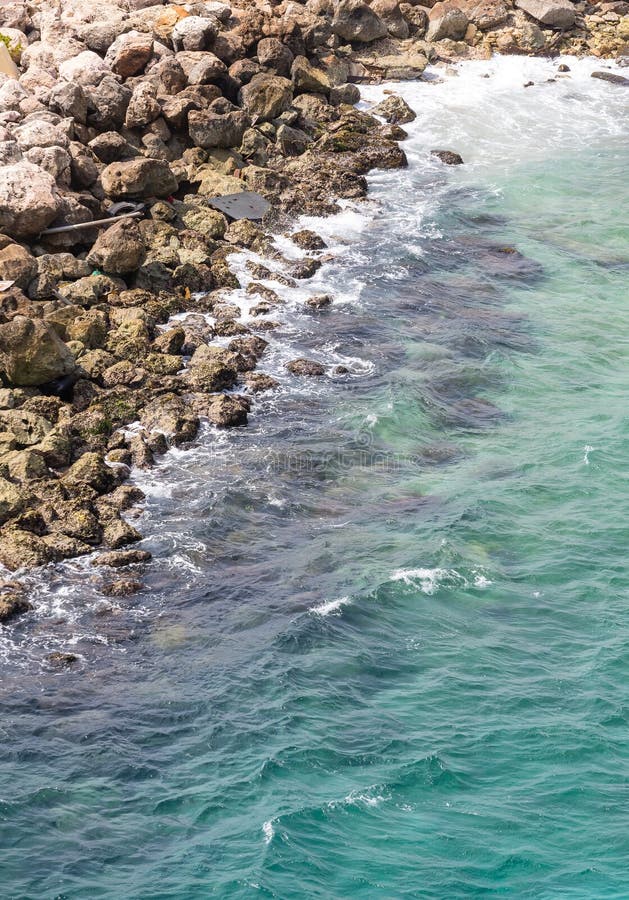Aqua Sea Against Rocks stock image. Image of crashing - 70072989