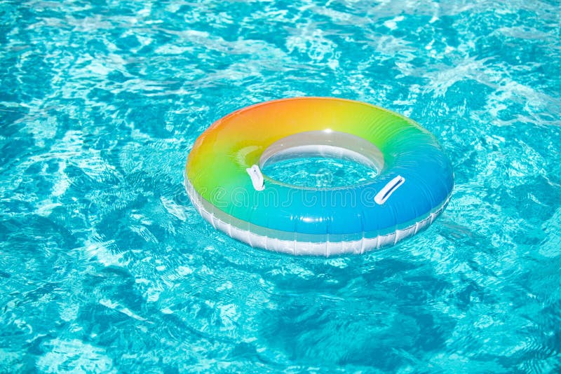 Blue Aqua Background. Pool Float, Rainbow Ring Floating in a Refreshing ...
