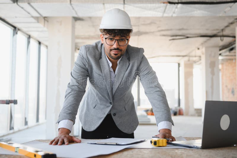 Arab Architect Inspecting Plans on Construction Site Stock Image ...