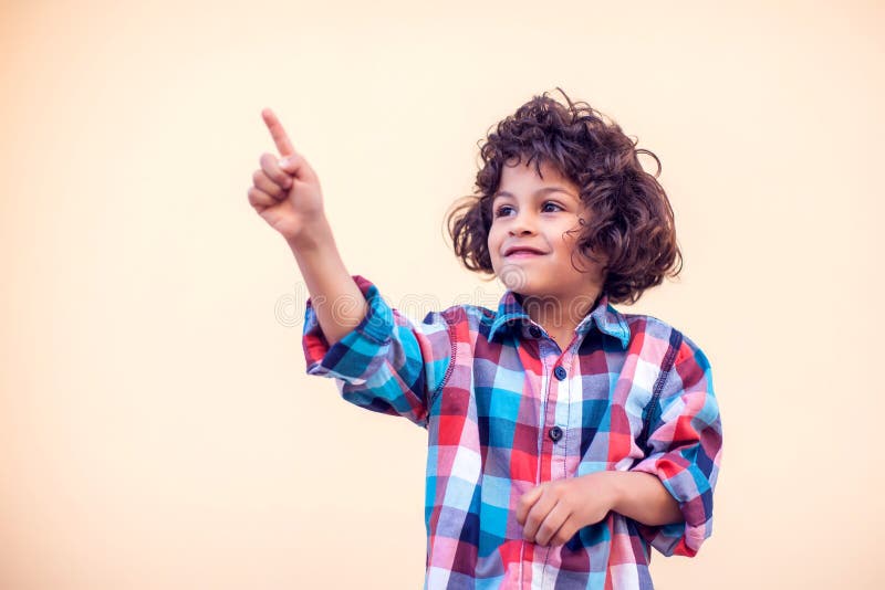 Arab Boy Looking at Far and Pointing His Finger with a Smile on His ...
