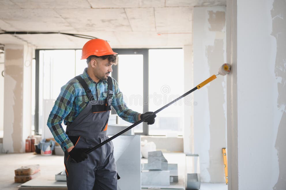 Arab Construction Worker Applying Primer on Walls with Roller Brush ...