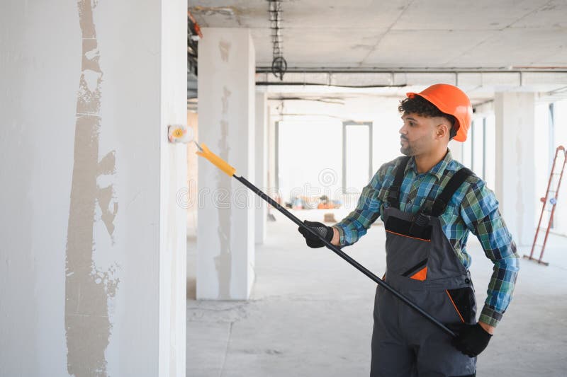 Arab Construction Worker Painting Walls with Roller in Building Under ...