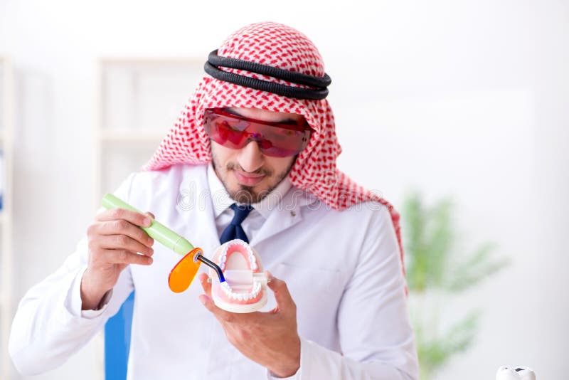The Arab Dentist Working on New Teeth Implant Stock Image - Image of ...
