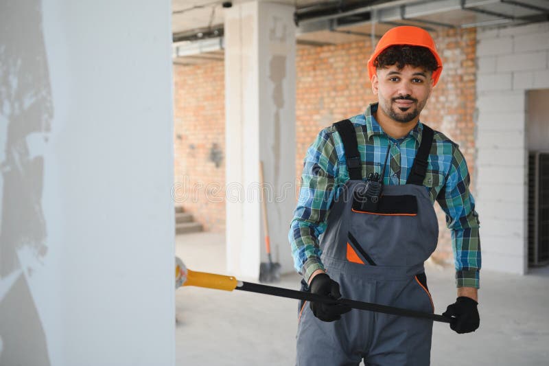 Arab Engineer Removing Plaster from Wall with Scraper in Construction ...