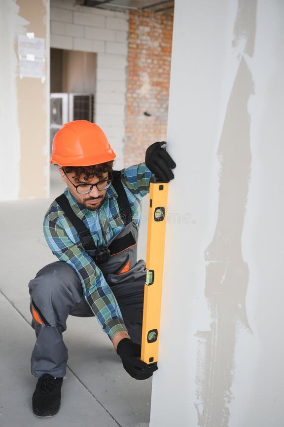 Arab Engineer Using Spirit Level on Construction Site Ensuring Vertical ...