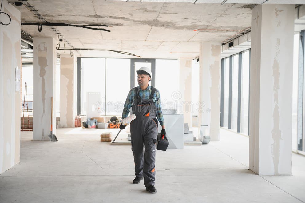 Arab Engineer Walking in Building Under Construction Carrying Tools ...