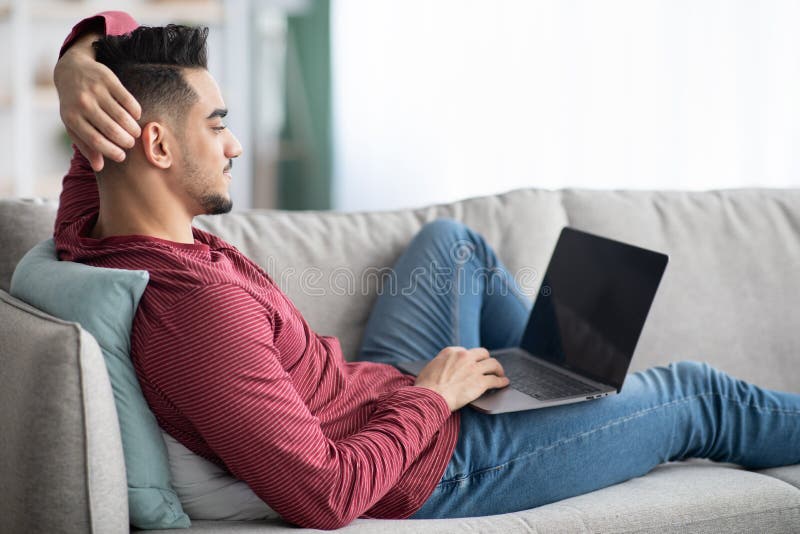 Arab Guy Using Laptop with Blank Screen, Home Interior Stock Image ...