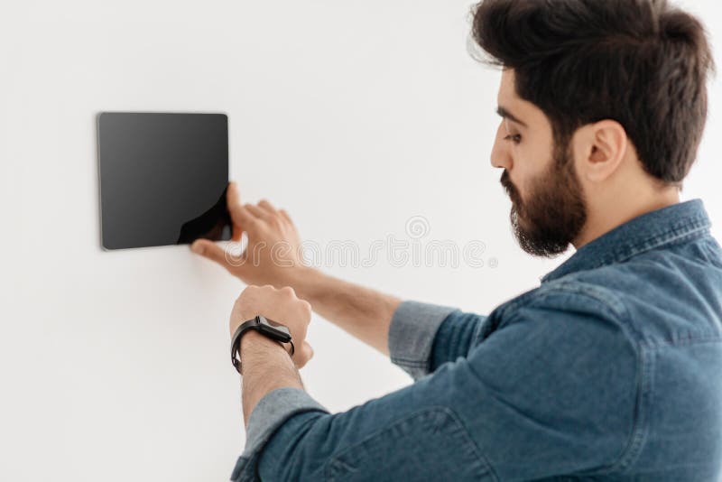Arab Guy Using Thermostat Smart Home Domotic Control Panel on Wall for ...