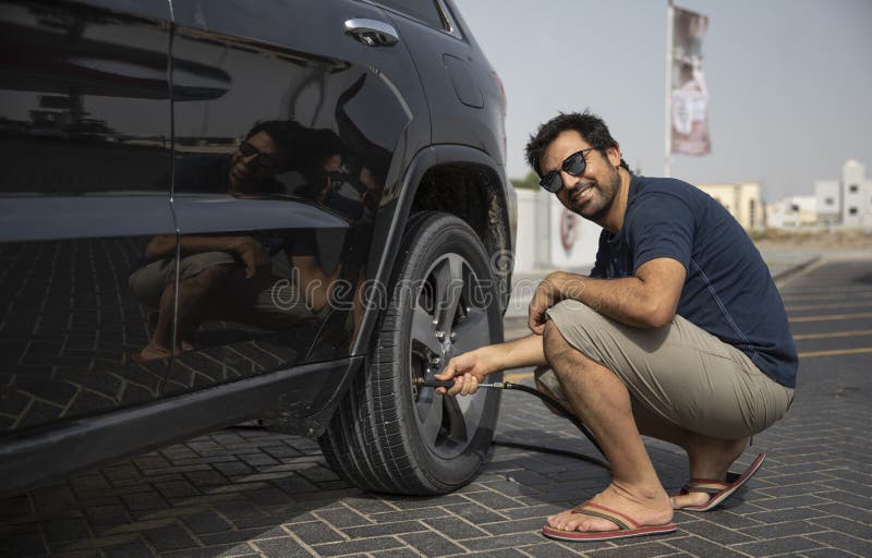 Arab Man Inflating Car Tyre Stock Photo - Image of person, bashing ...