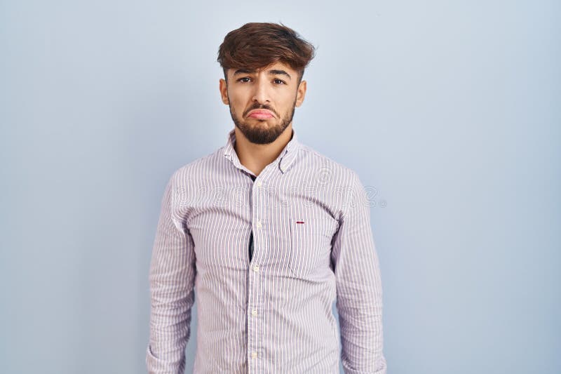 Arab Man with Beard Standing Over Blue Background Depressed and Worry ...