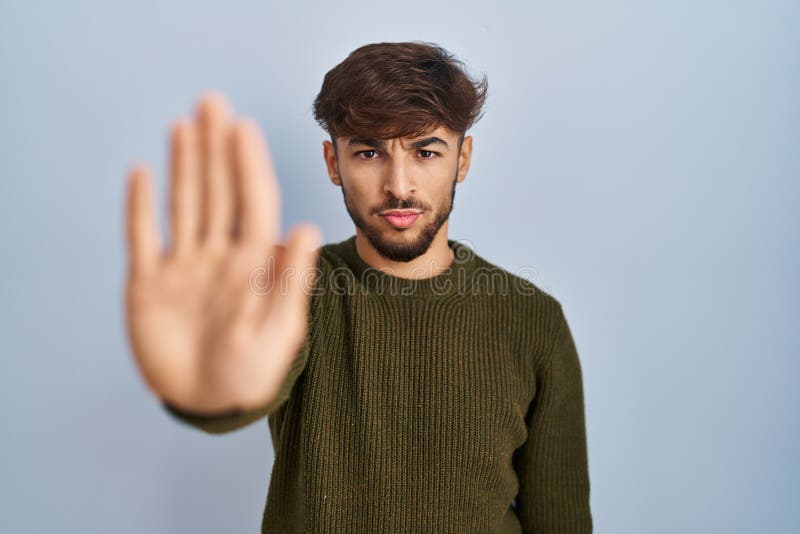 Arab Man with Beard Standing Over Blue Background Doing Stop Sing with ...