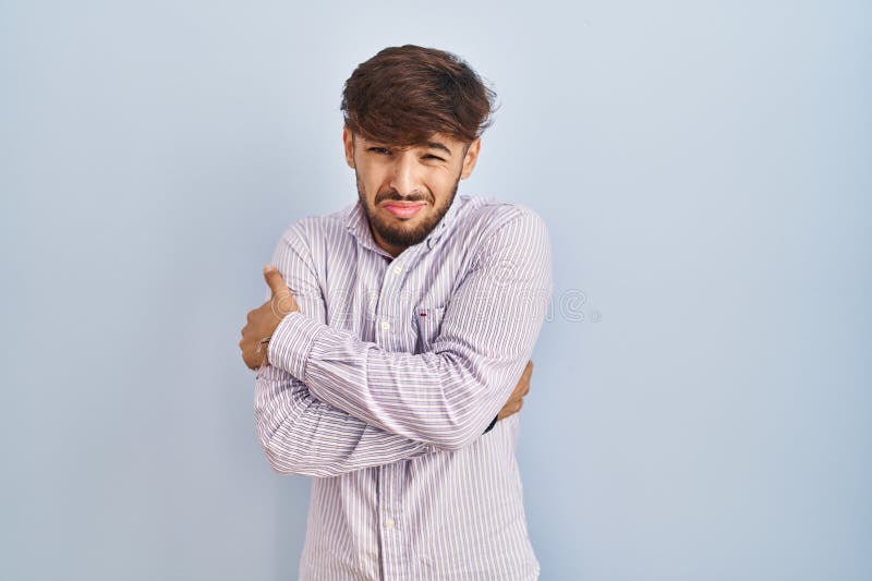 Arab Man with Beard Standing Over Blue Background Shaking and Freezing ...