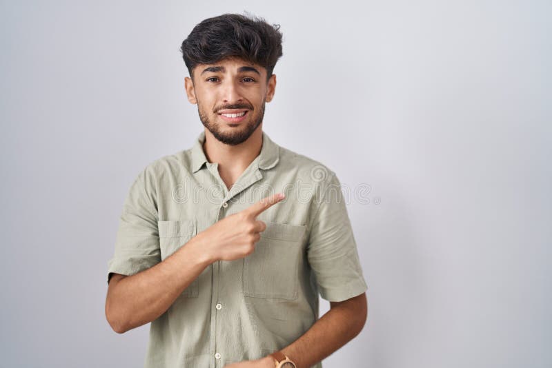 Arab Man with Beard Standing Over White Background Pointing Aside ...