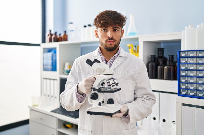 Arab Man with Beard Working at Scientist Laboratory Holding Microscope ...