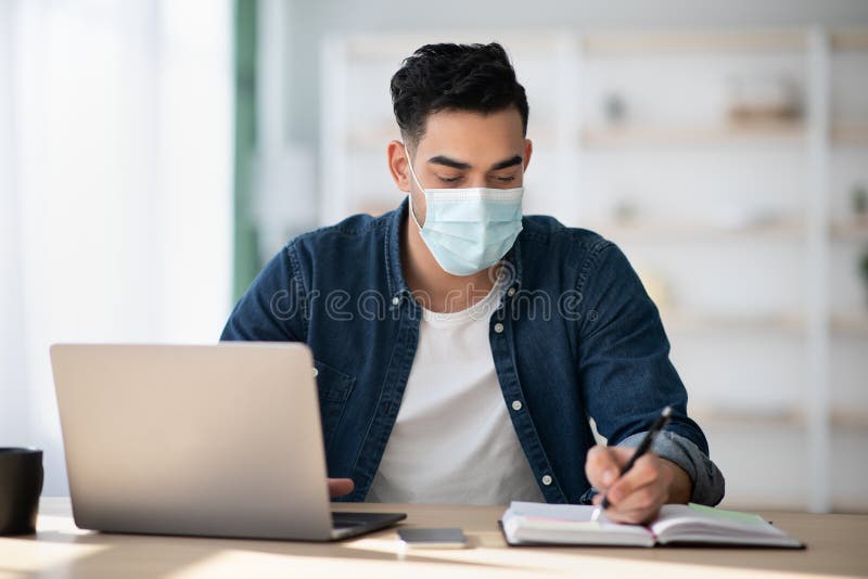 Arab Man in Protective Face Mask Using Laptop, Taking Notes Stock Image ...