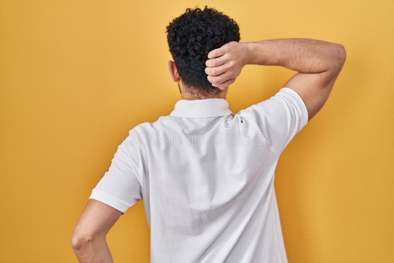 Arab Man Standing Over Yellow Background Backwards Thinking about Doubt ...
