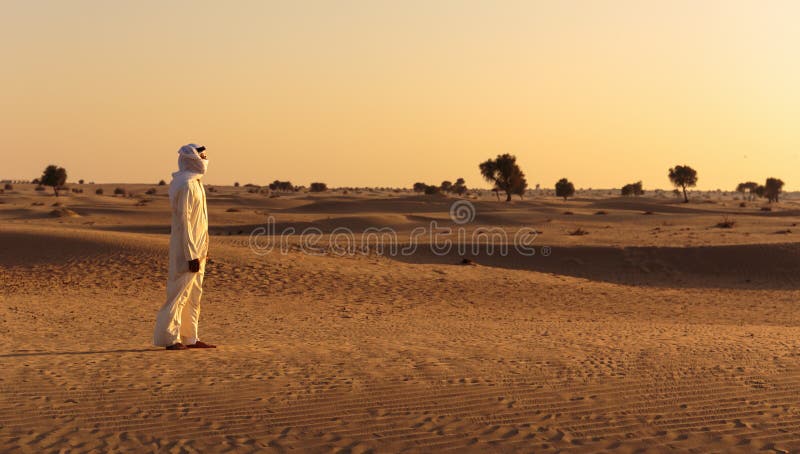 Arab Man Stands Alone in the Desert and Watching the Sunset Stock Photo ...