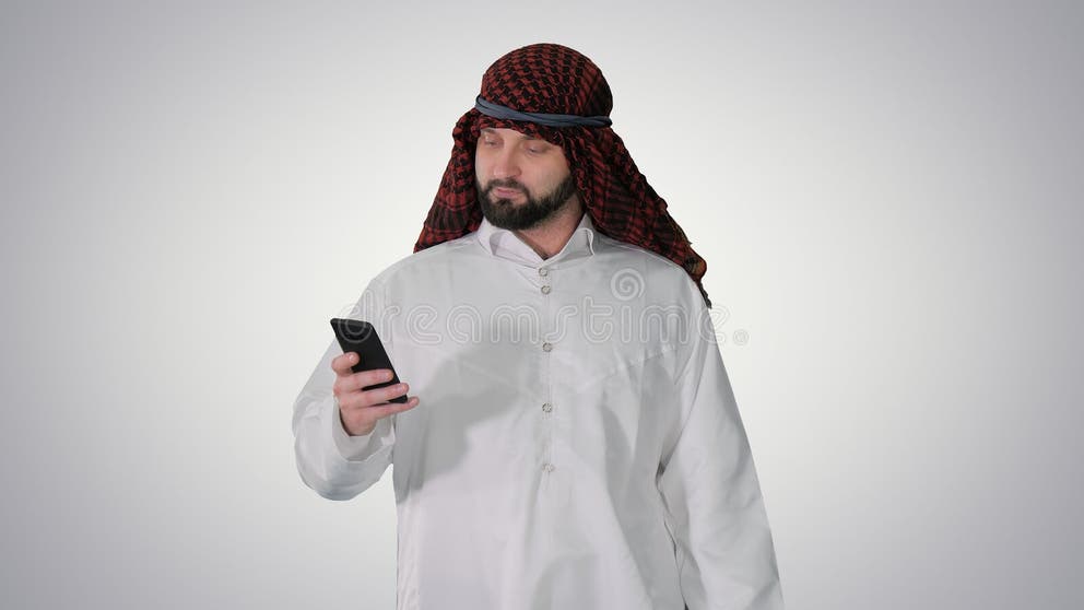 Arab Man Using His Smartphone Surfing on the Internet or Messagi Stock ...