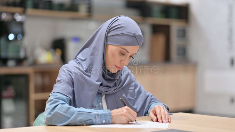 Arab Woman Writing on Paper at Work Stock Photo - Image of data ...