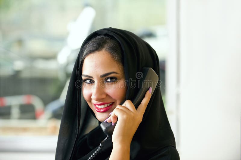 Arabian Receptionist Helping A Customer On The Front Desk Stock Photo ...