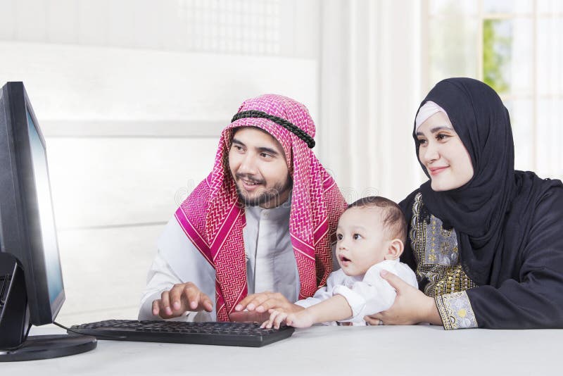 Arabian Family Using a Computer at Home Stock Photo - Image of father ...