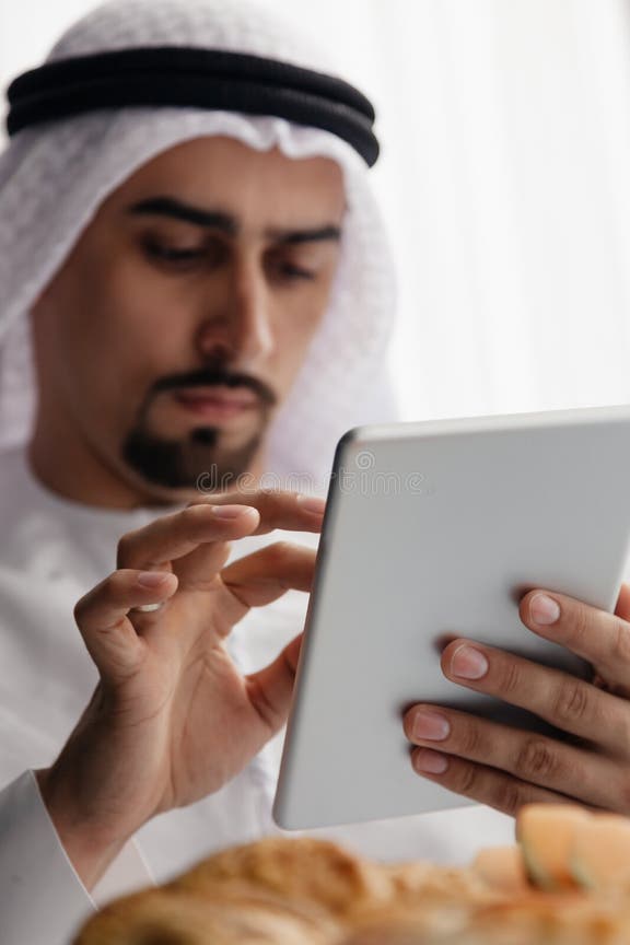 Arabian Male Using Tablet during Breakfast Stock Image - Image of ...