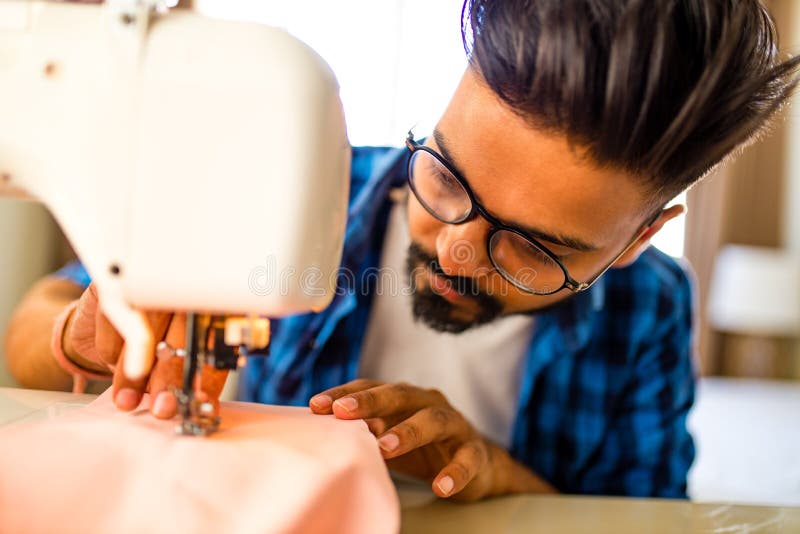 Arabian Man Designer Sewing Clothes on Sewing Machine in Studio ...