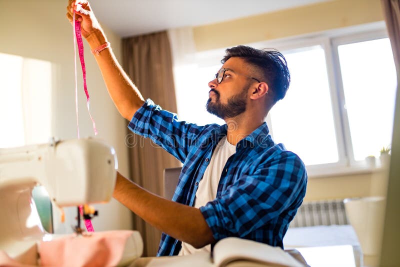 Arabian Man Designer Sewing Clothes on Sewing Machine in Studio ...