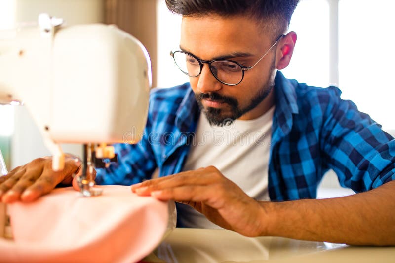 Arabian Man Designer Sewing Clothes on Sewing Machine in Studio ...