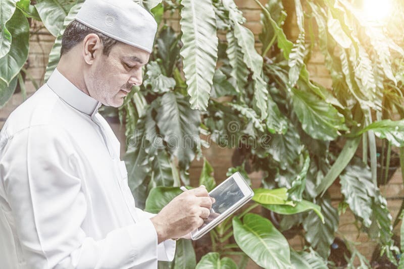 Arabian Muslim Businessman Working on Tablet Computer Stock Photo ...