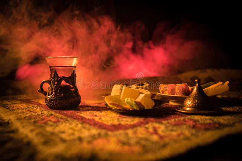 Arabian Tea in Glass with Eastern Snacks on a Carpet on Dark Background ...
