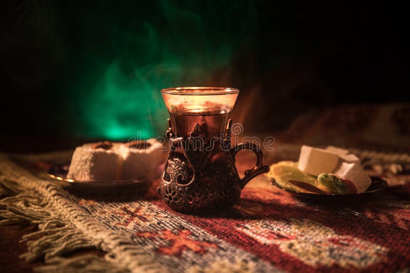 Arabian Tea in Glass with Eastern Snacks on a Carpet on Dark Background ...