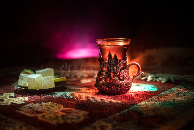 Arabian Tea in Glass with Eastern Snacks on a Carpet on Dark Background ...