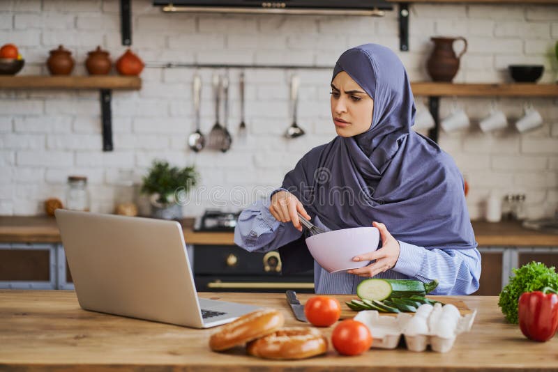 Arabian Woman Watching a Cooking Tutorial and Whipping with a Whisker ...