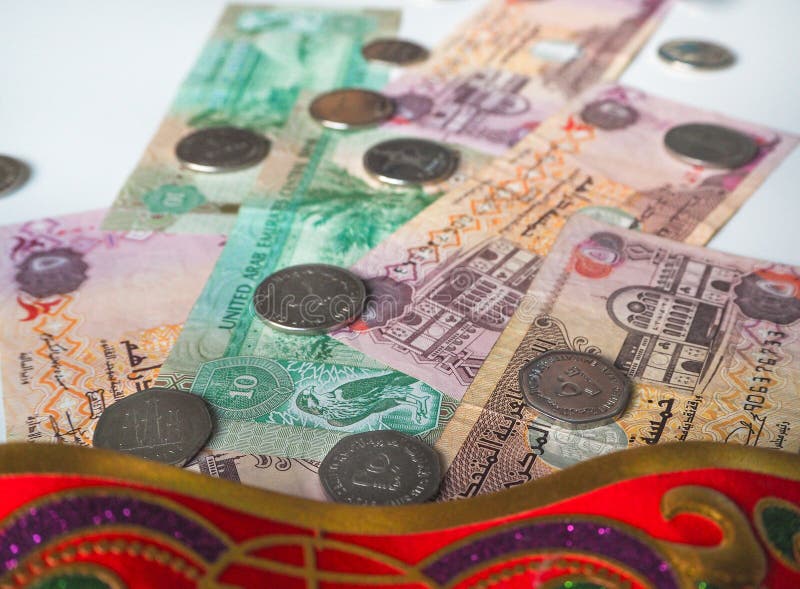 Arabic Coins of Dirhams. Curled Banknotes in His Hands. Stock Photo ...