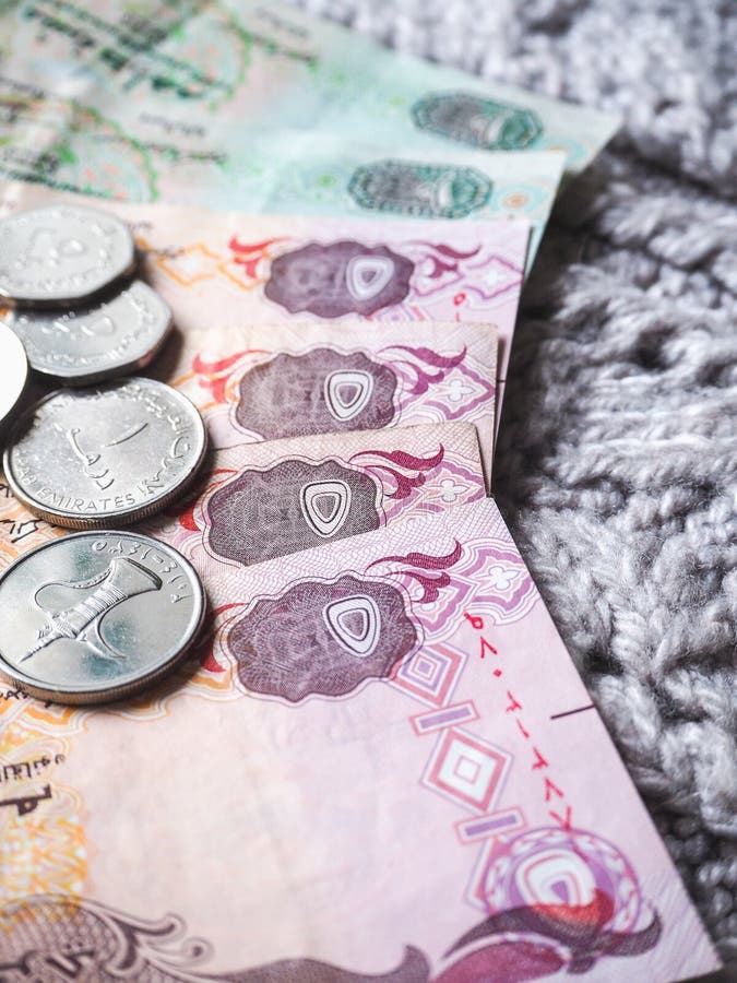 Arabic Coins of Dirhams. Curled Banknotes in His Hands. Stock Photo ...